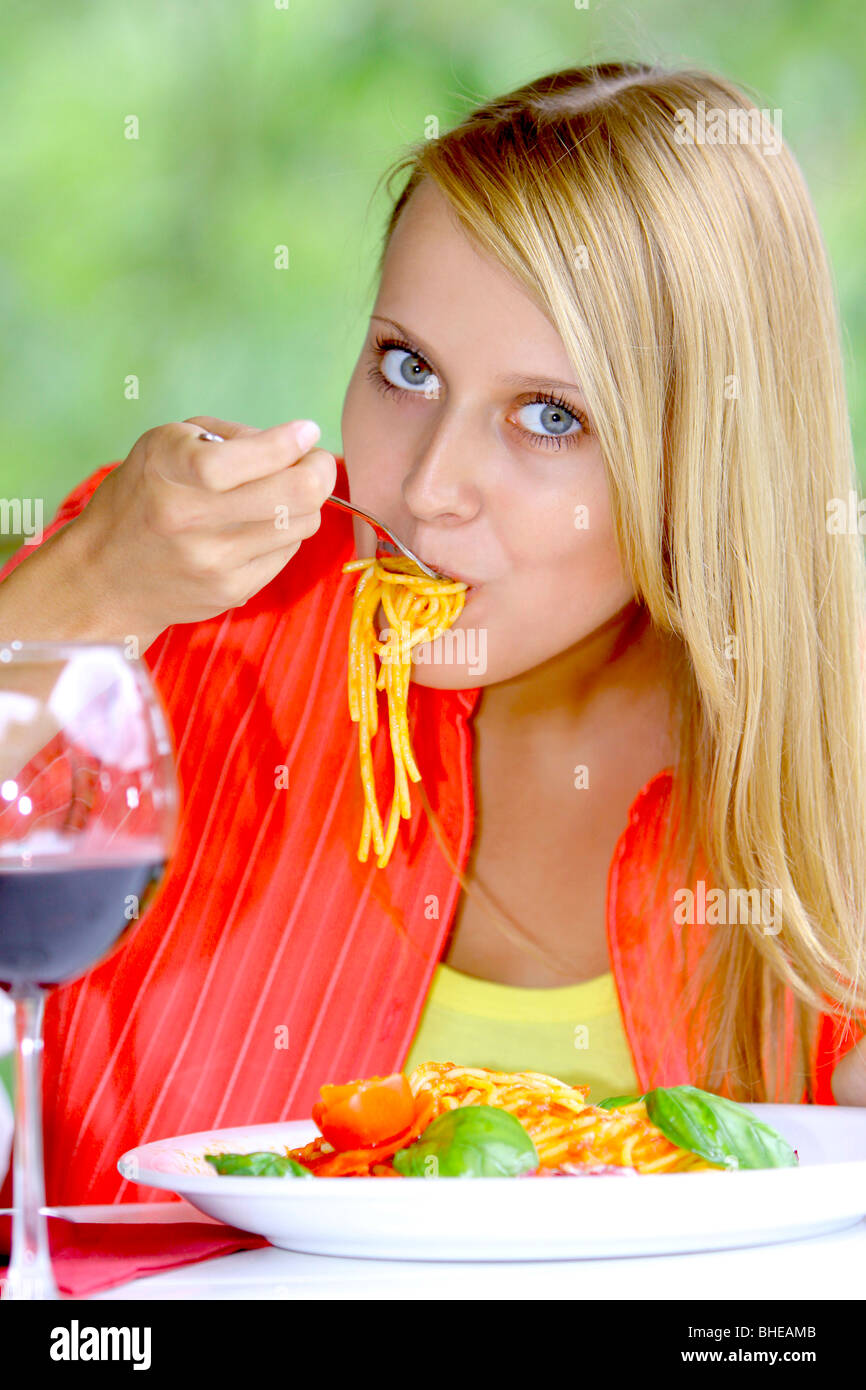 Young woman eating spaghetti on vacation Stock Photo - Alamy