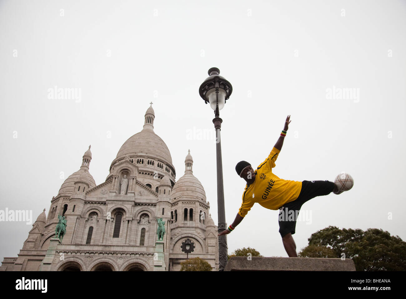 Acrobatic football player in front of the Sacred Heart church in Paris ...