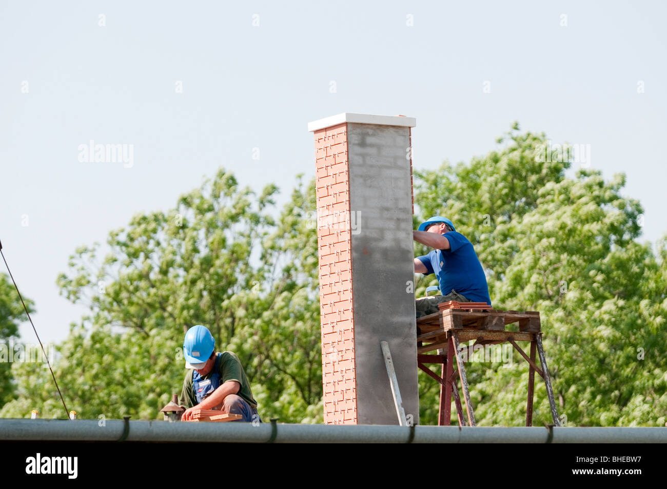 Men building chimney stack in Kisujszallas Hungary Eastern Europe Stock ...