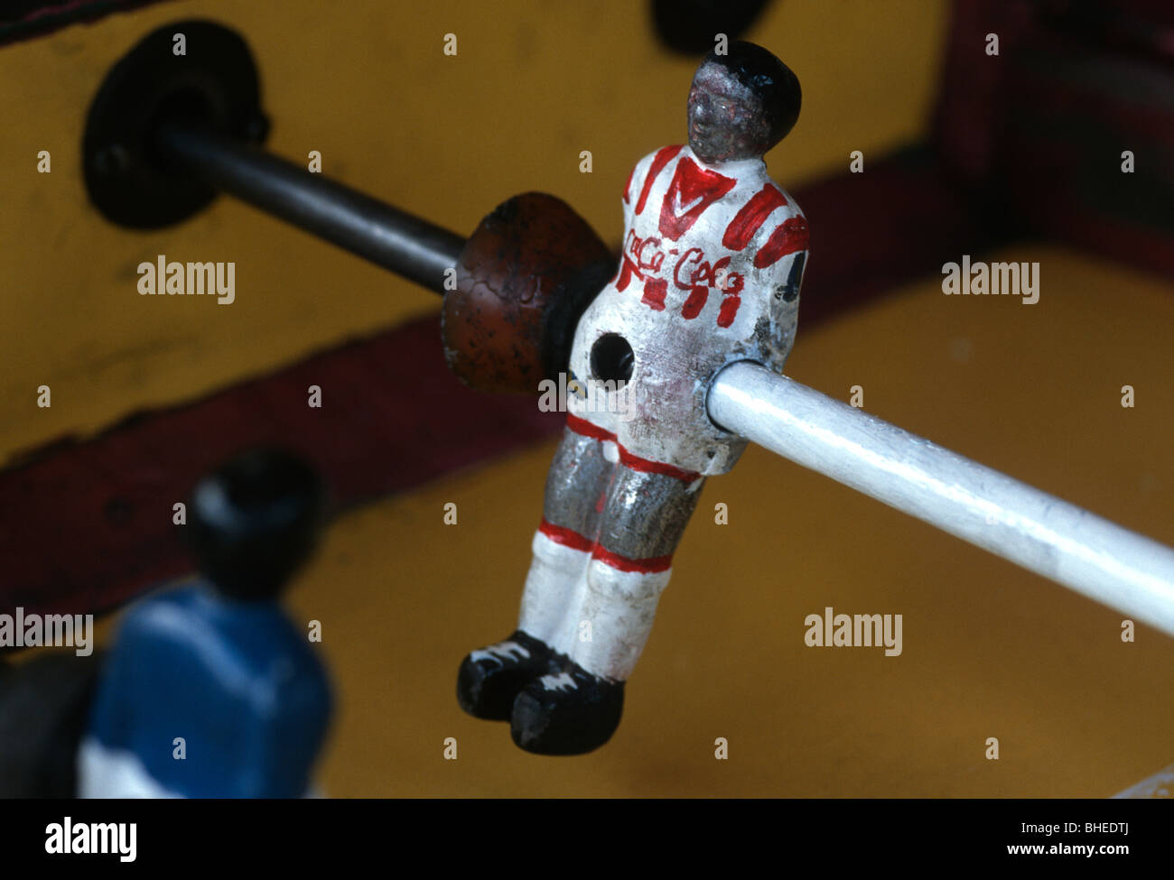 A close up of a table football player painted with a Coca-cola shirt ...