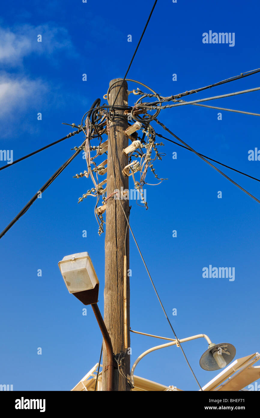 A power pole and distribution point with street lights on Santorini ...
