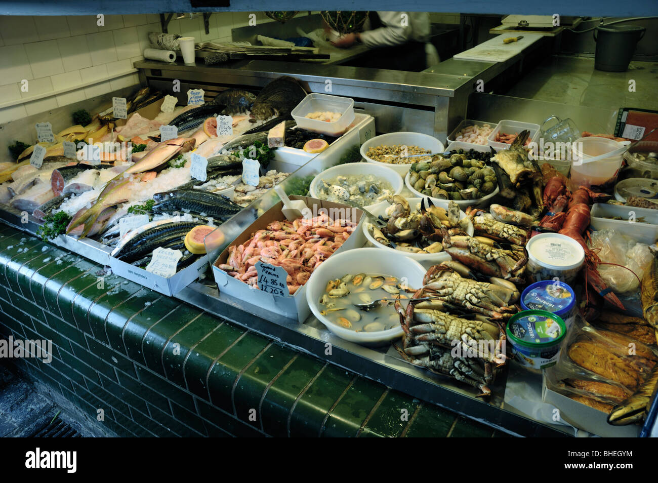 A traditional fishmongers slab with fish and seafood, including crabs ...