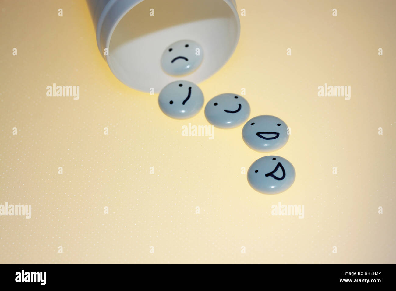 White tablets with mood faces on light background Stock Photo - Alamy