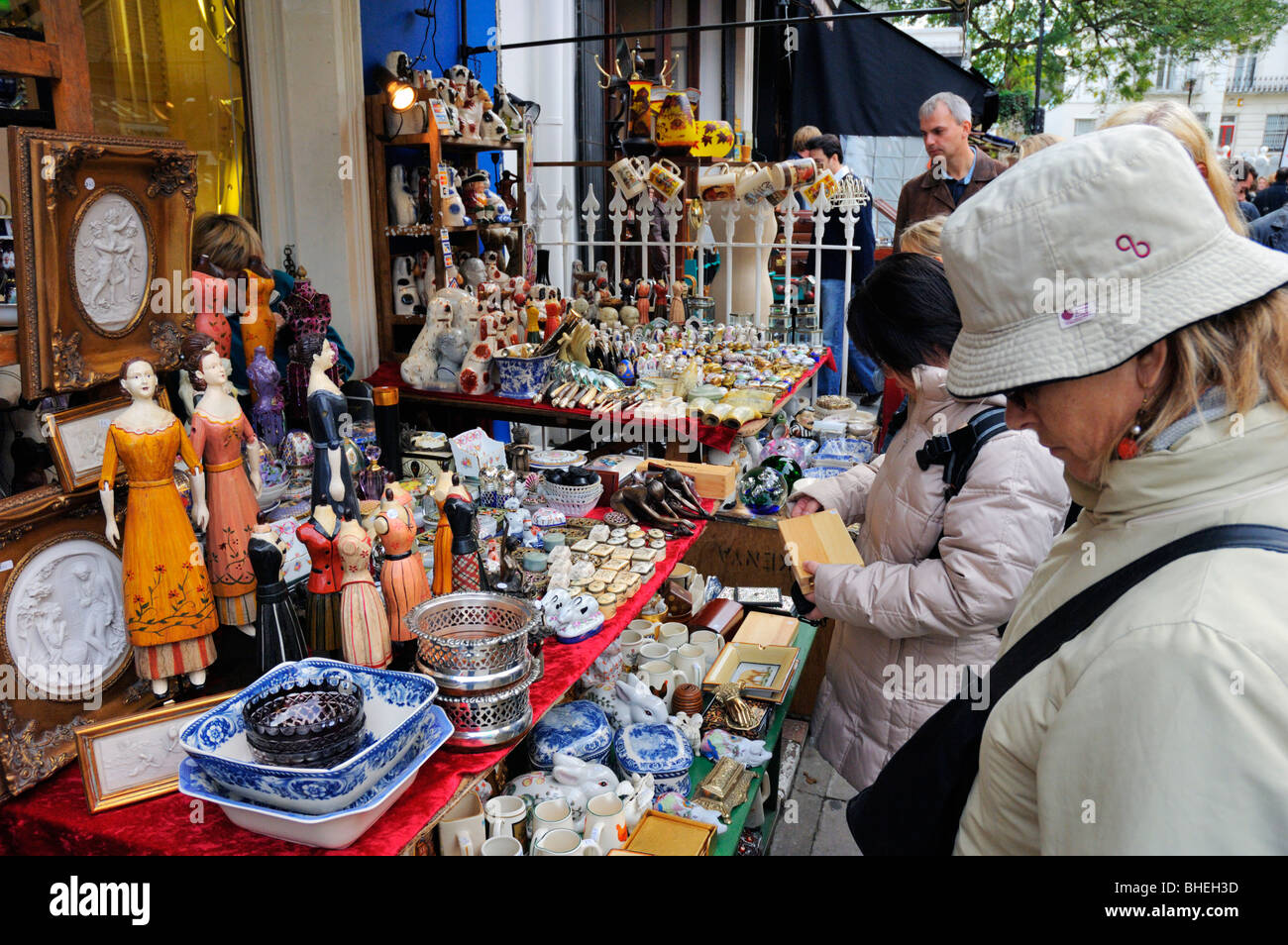Tourists and customers viewing antiques and vintage items at the ...