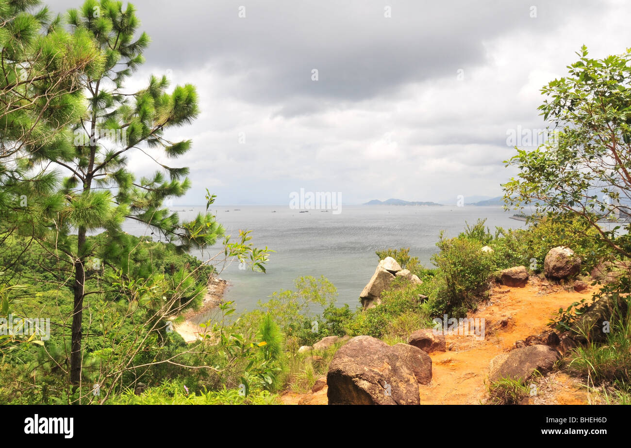 Sunny South China Sea view, pine tree, red soil, granite rocks on the ...