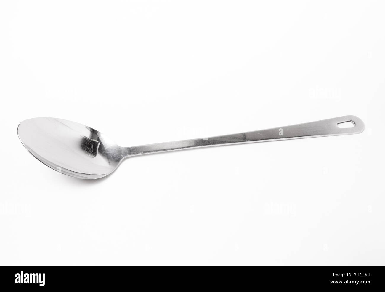 Large Stainless steel Kitchen spoon isolated against white background ...