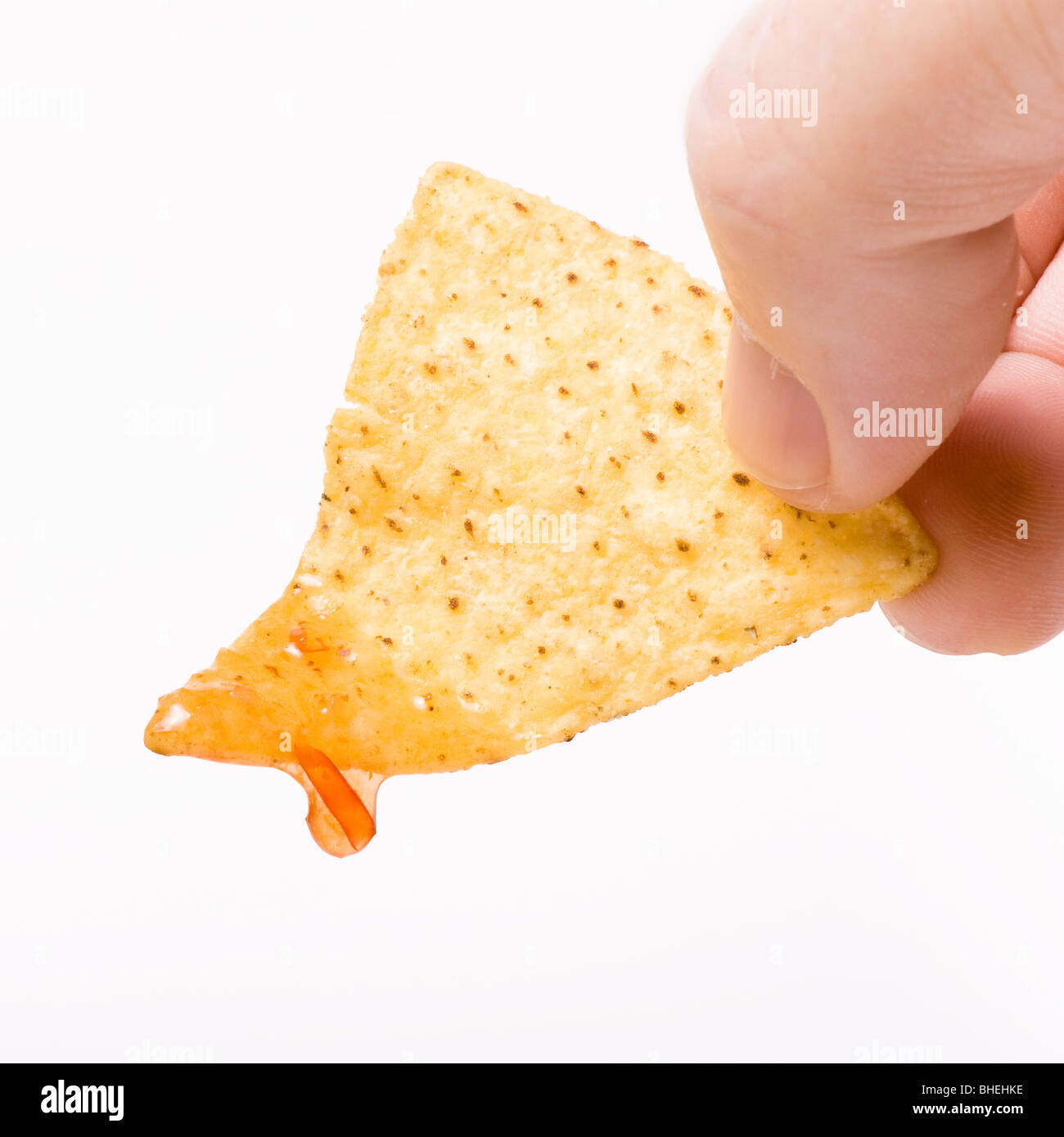 Tortilla Chips or nachos dripping and oozing sauce isolated against ...