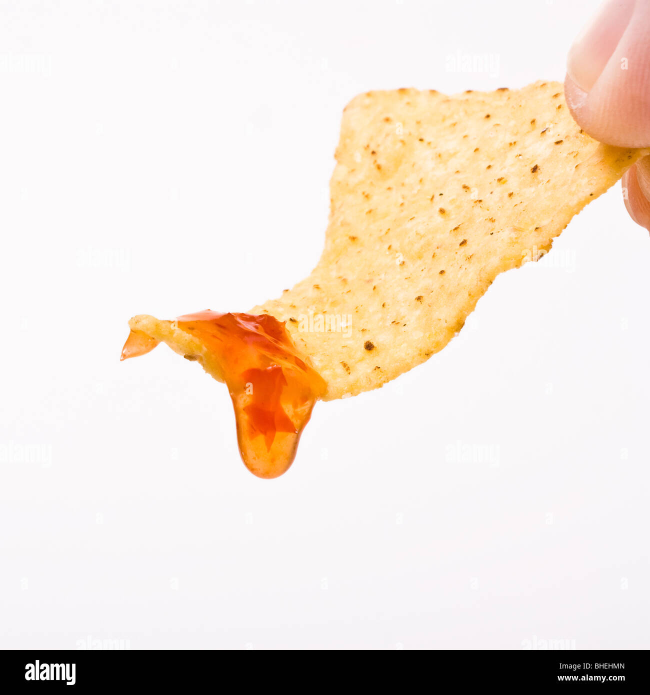 Tortilla Chips or nachos dripping and oozing sauce isolated against ...