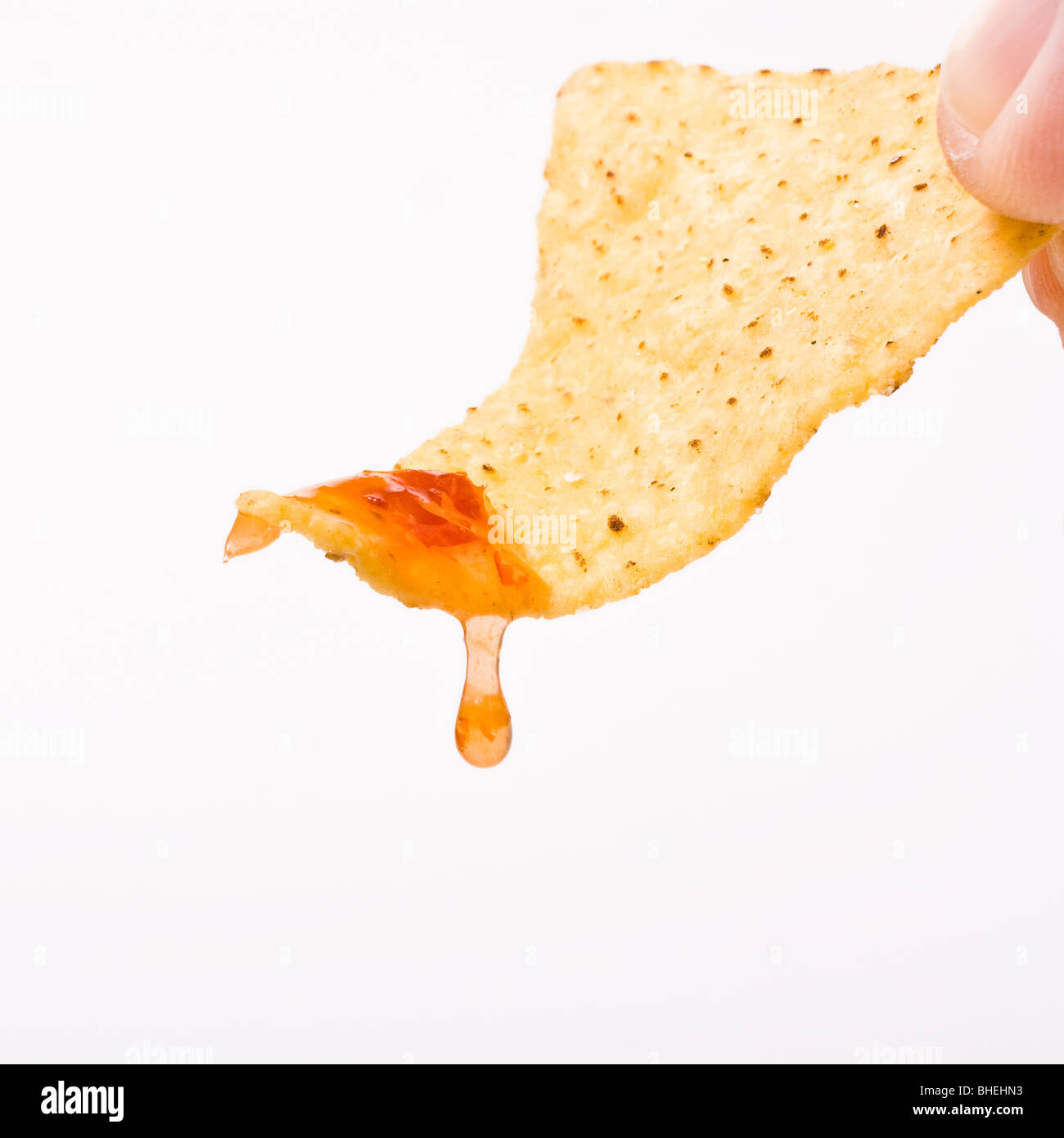 Tortilla Chips or nachos dripping and oozing sauce isolated against ...