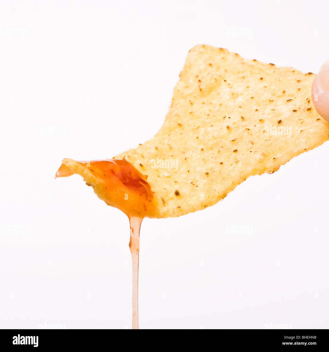 Tortilla Chips or nachos dripping and oozing sauce isolated against ...