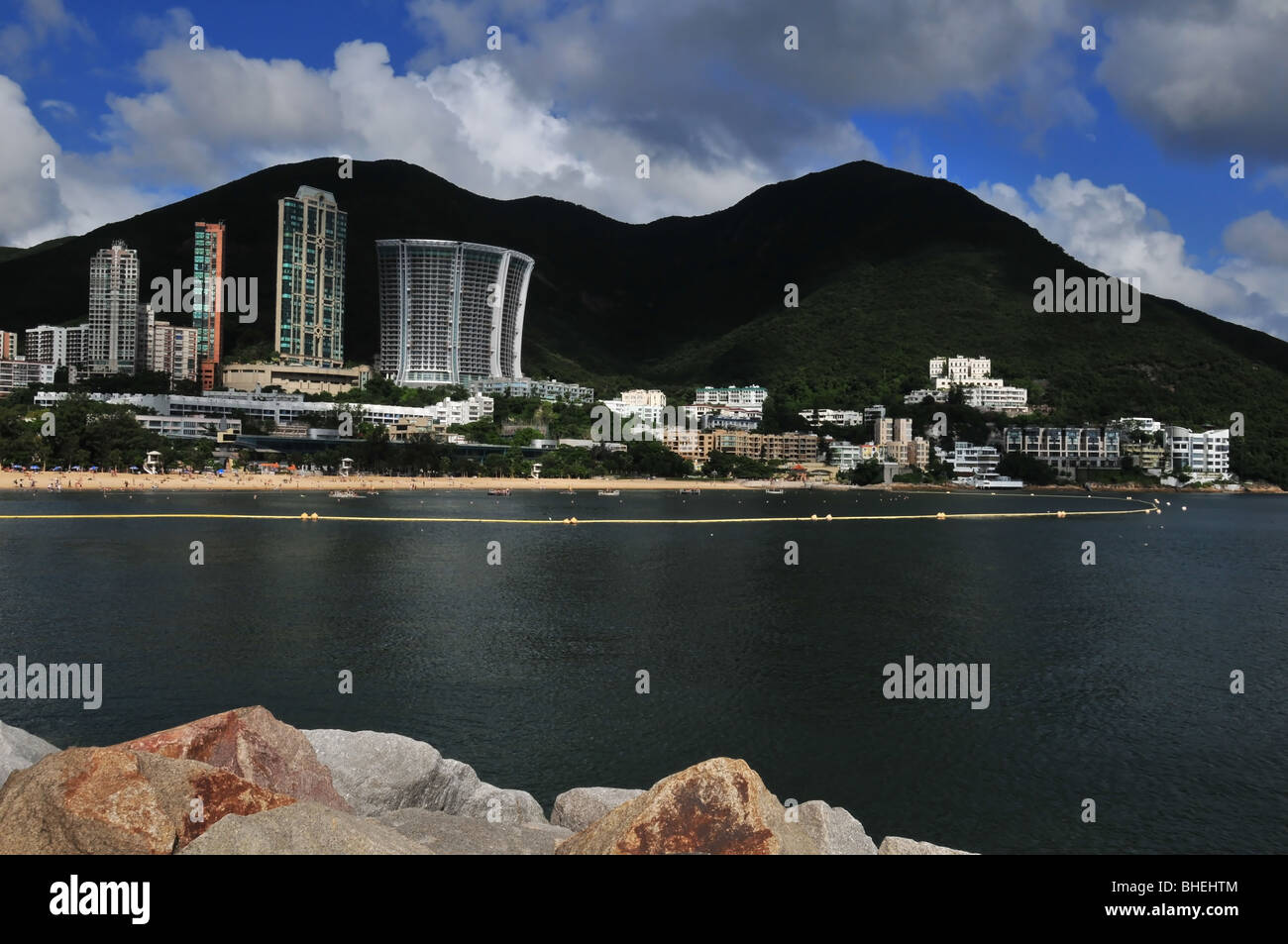 Sunny view of the shark net beach area and luxury apartments, against a ...