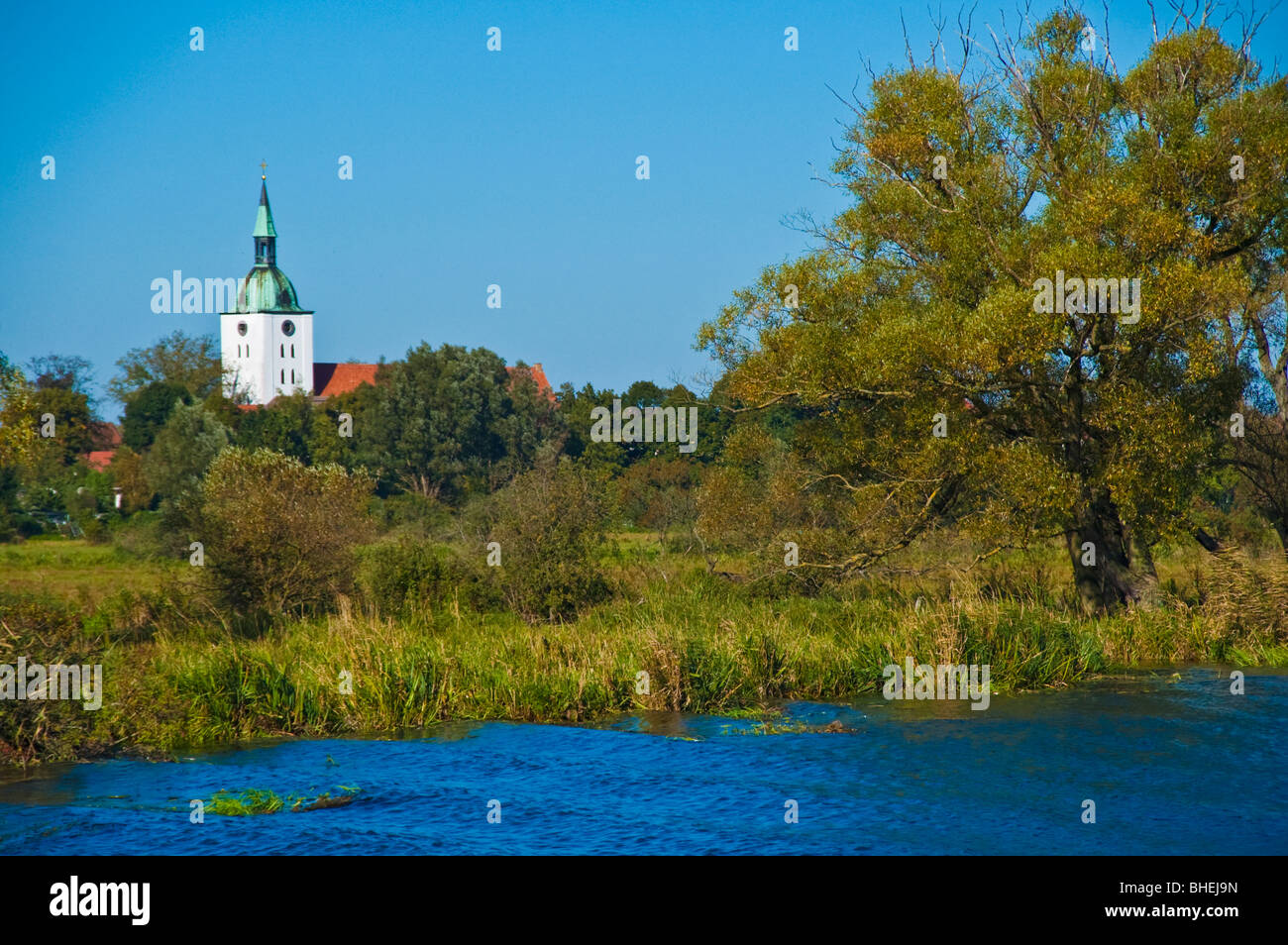 Church tower at Loitz from Peene river, Mecklenburg-Western Pomerania ...