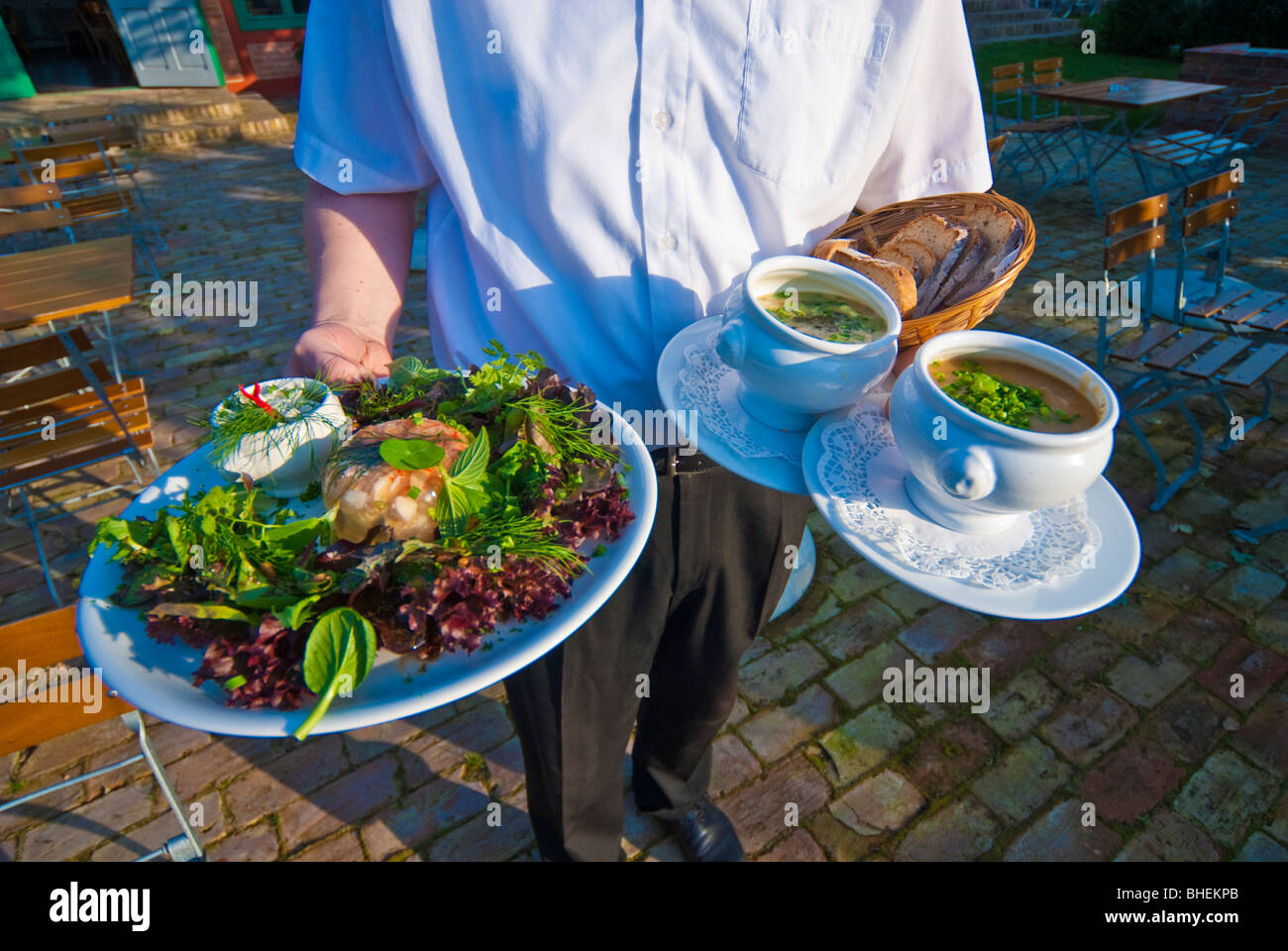 Waiter serving food plates hi-res stock photography and images - Alamy