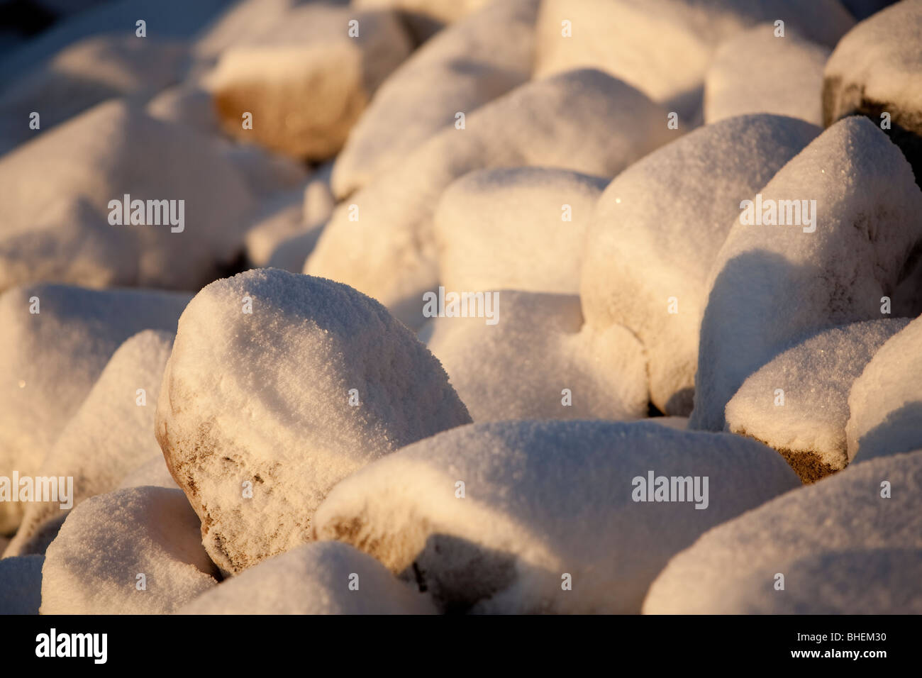 Snow covered stones Stock Photo - Alamy