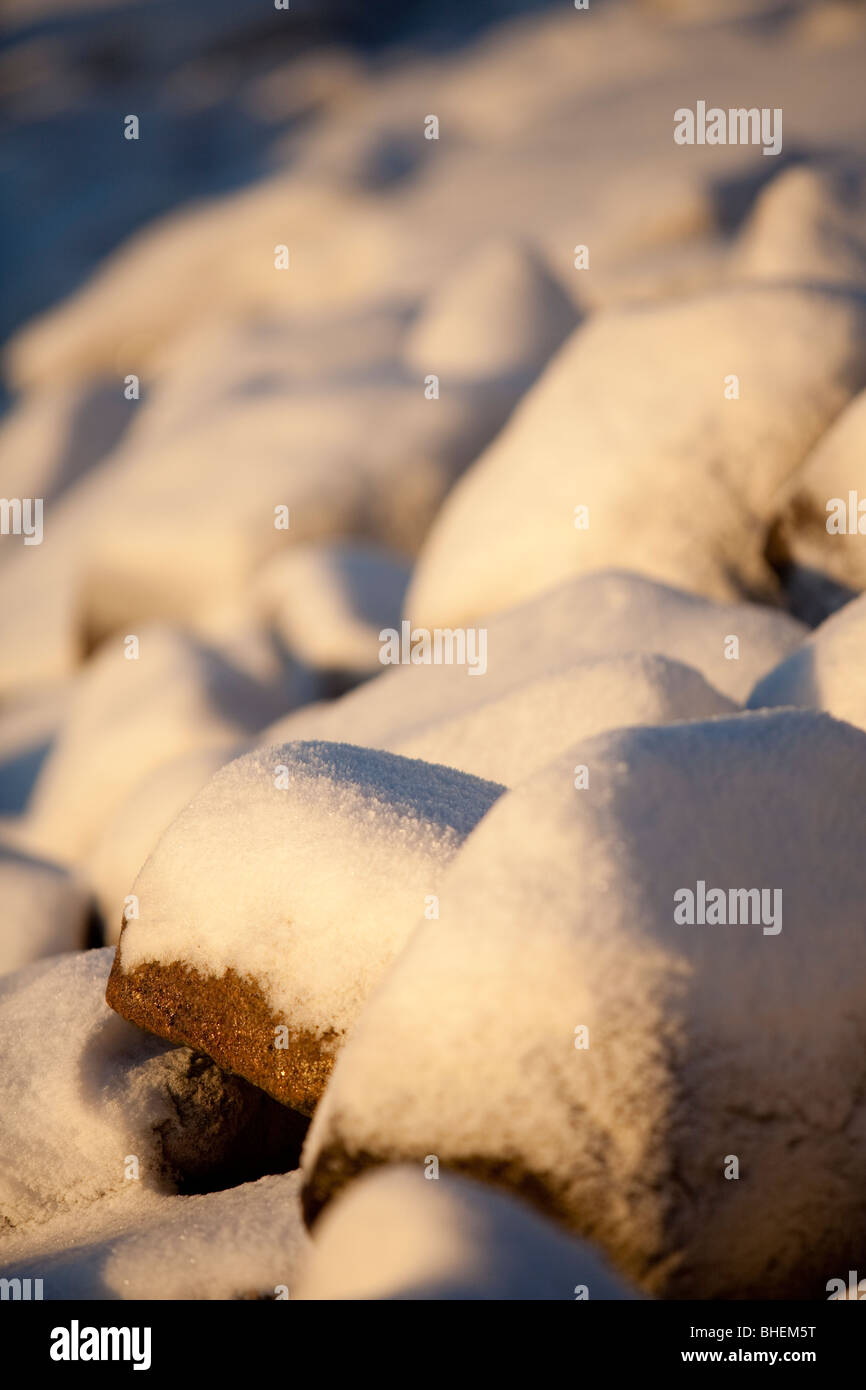 Snow covered stones Stock Photo - Alamy
