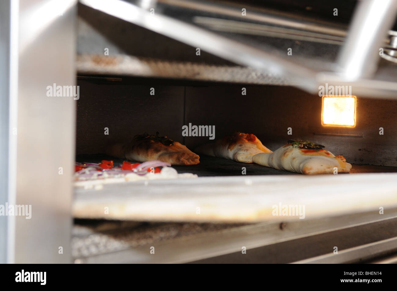 calzone baking in an oven Stock Photo - Alamy
