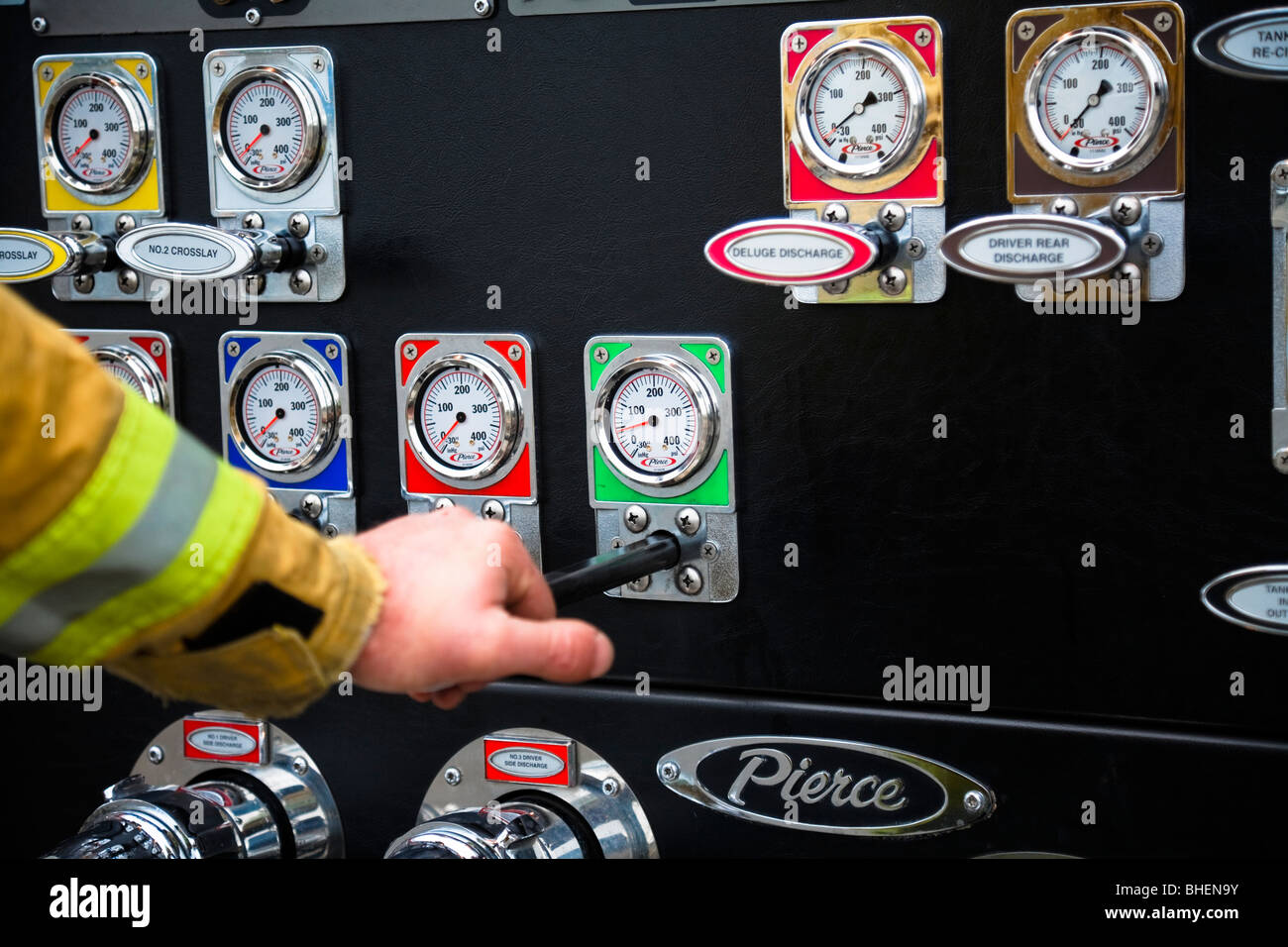 Hand and arm of a fireman operating the pressure systems on a fire ...