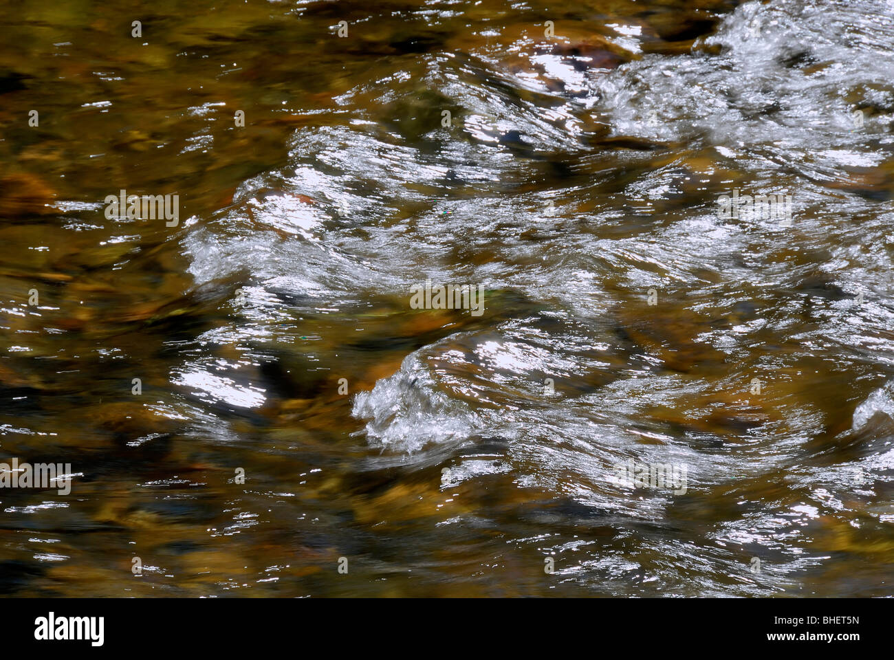 Water flowing over the riverbed Stock Photo - Alamy