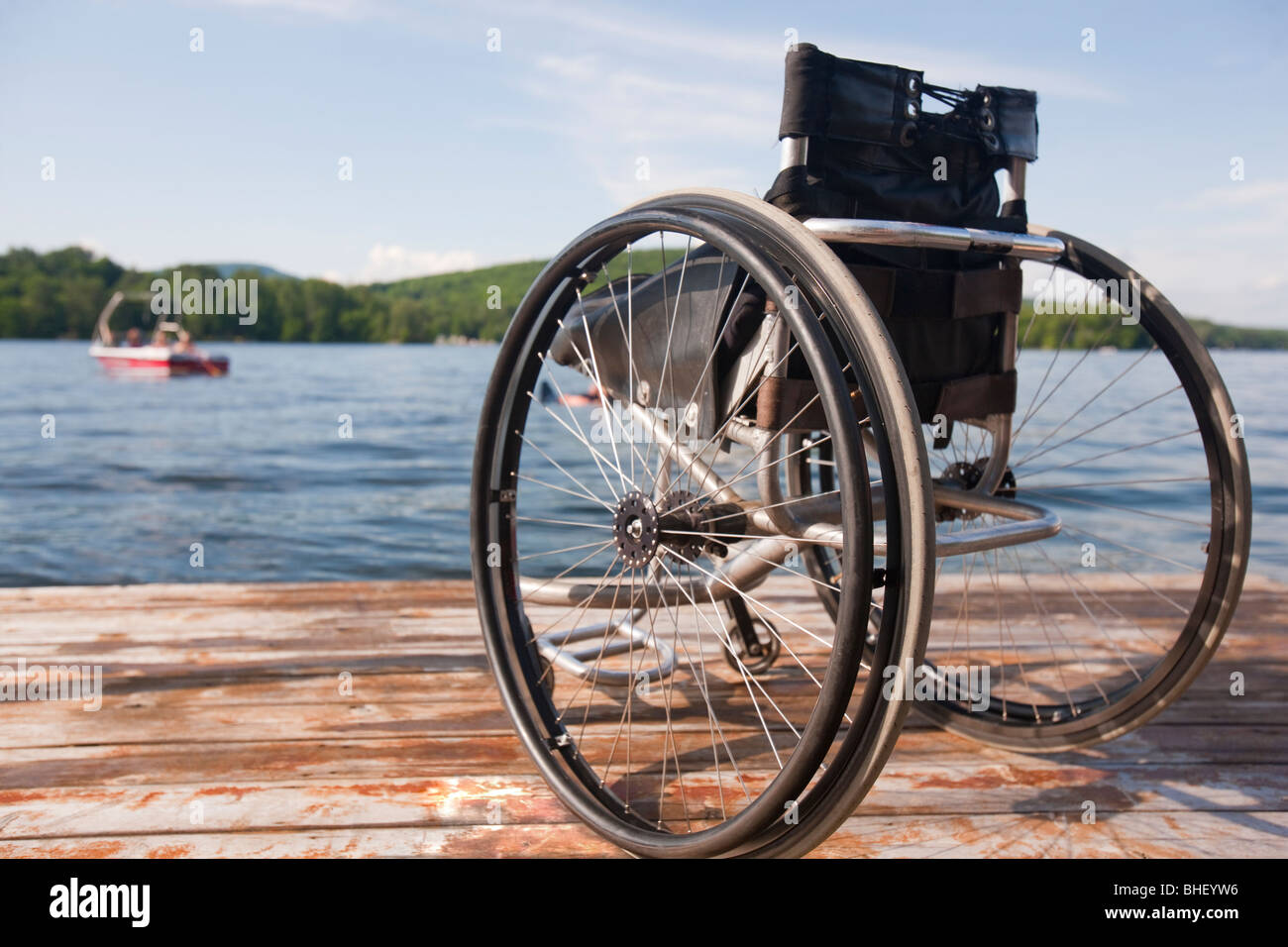 Close-up of a wheelchair on a dock Stock Photo - Alamy