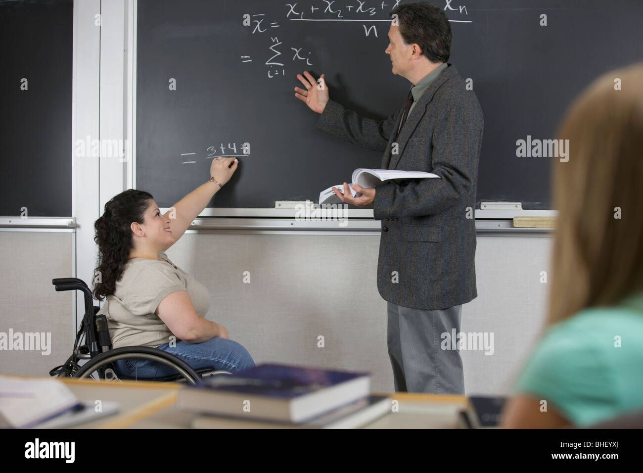 Professor with disabled student in a classroom Stock Photo - Alamy