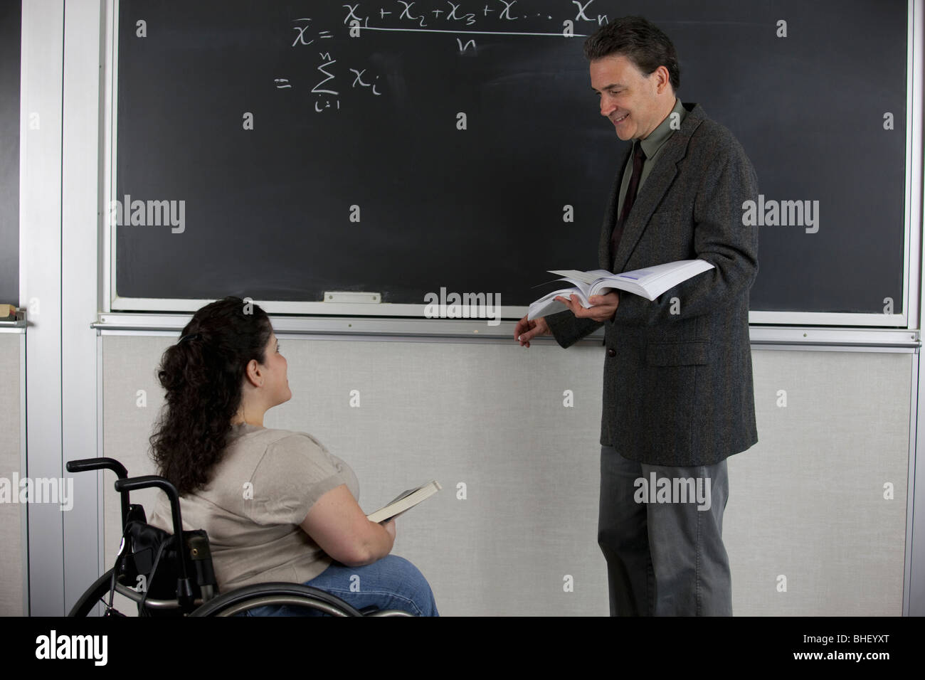 Professor with disabled student in a classroom Stock Photo - Alamy