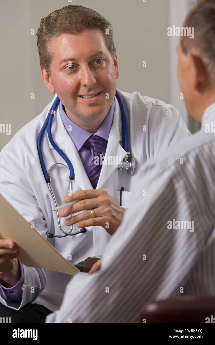 Doctor consulting with a patient Stock Photo - Alamy