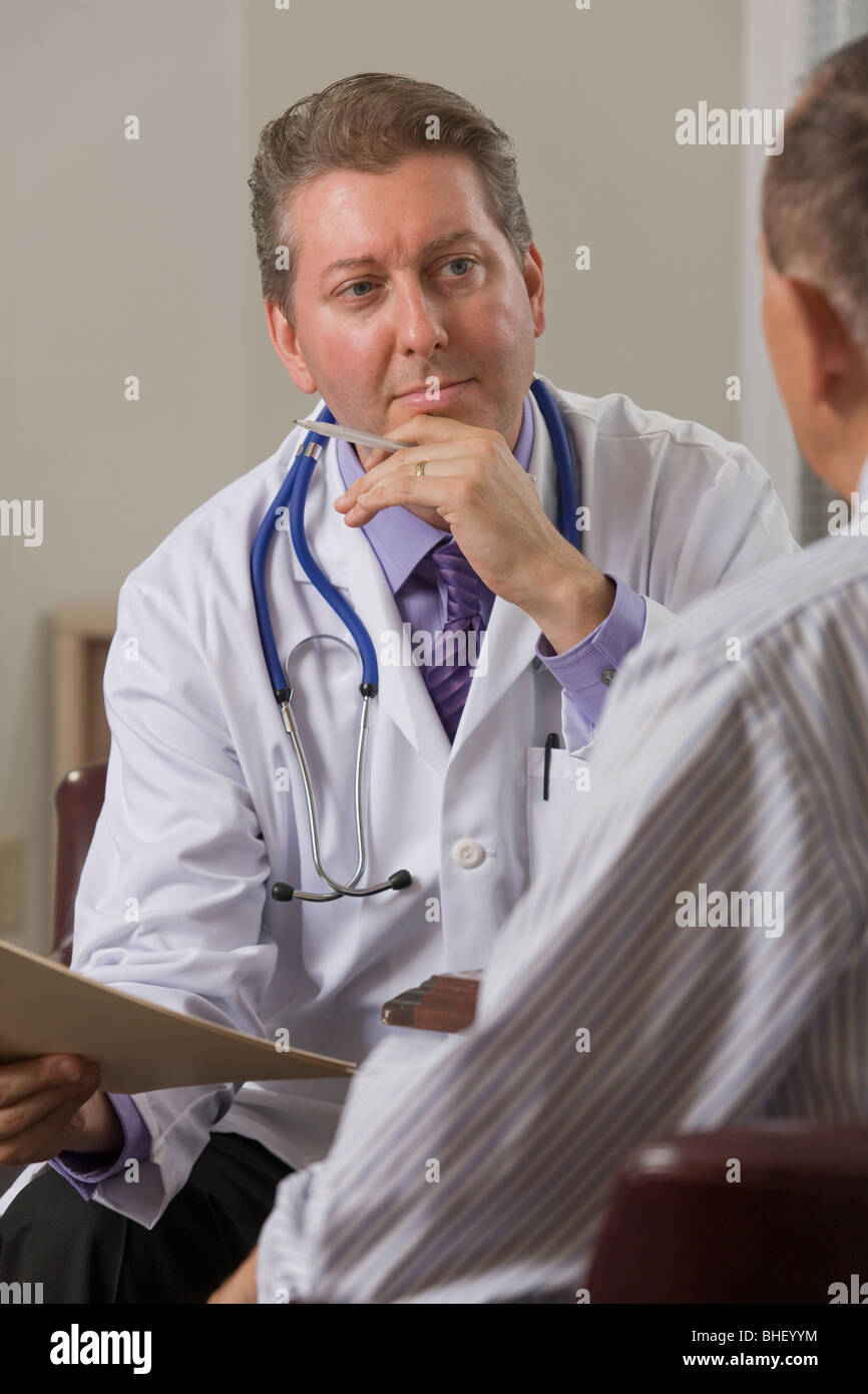 Doctor consulting with a patient Stock Photo - Alamy