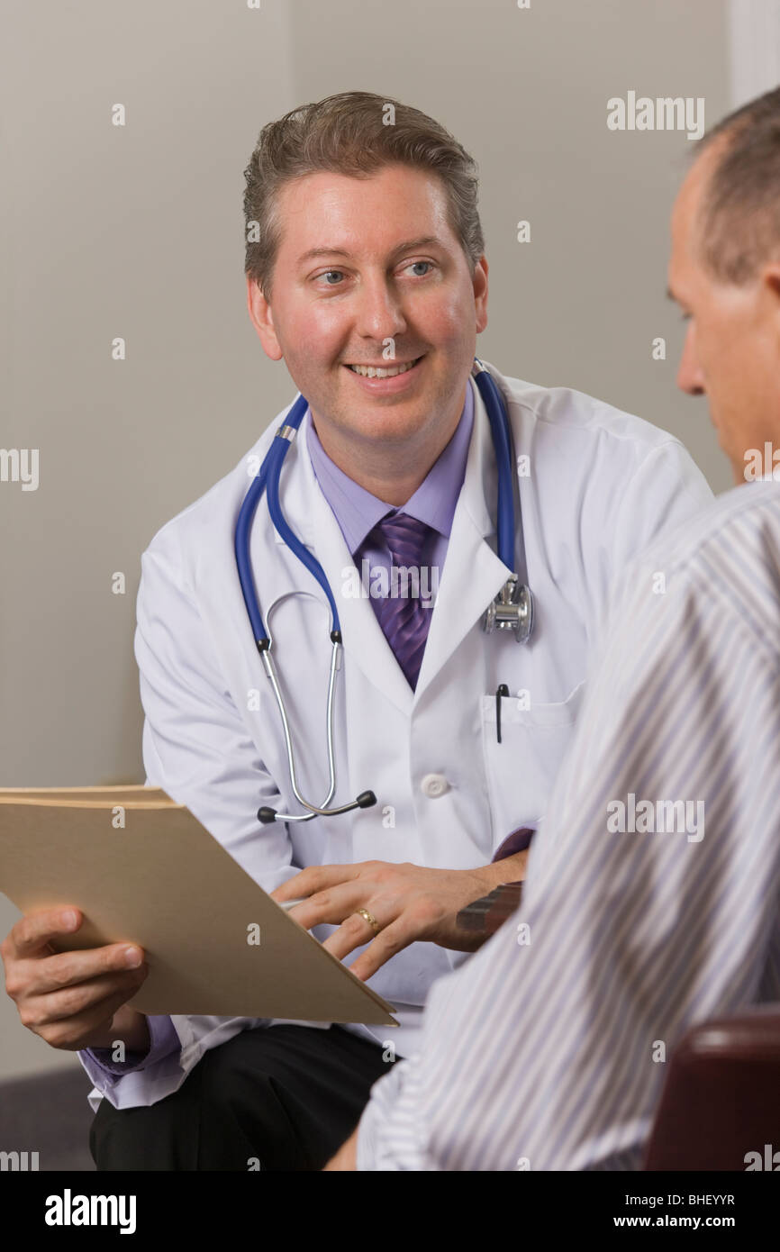 Doctor consulting with a patient Stock Photo - Alamy