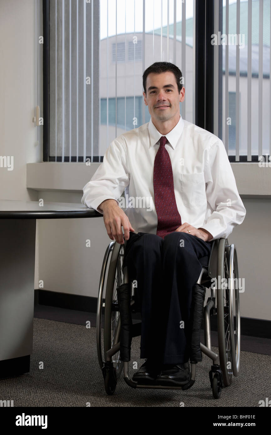Handicapped businessman sitting in an office Stock Photo - Alamy