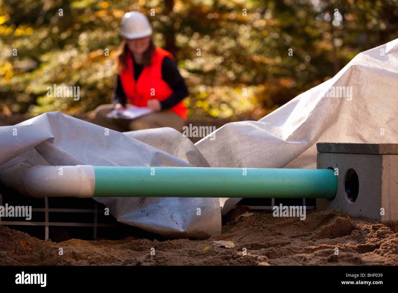 Sewage piping with a female engineer sitting in the background Stock ...