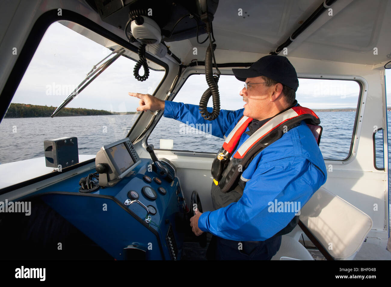 Security guard controlling a boat Stock Photo - Alamy