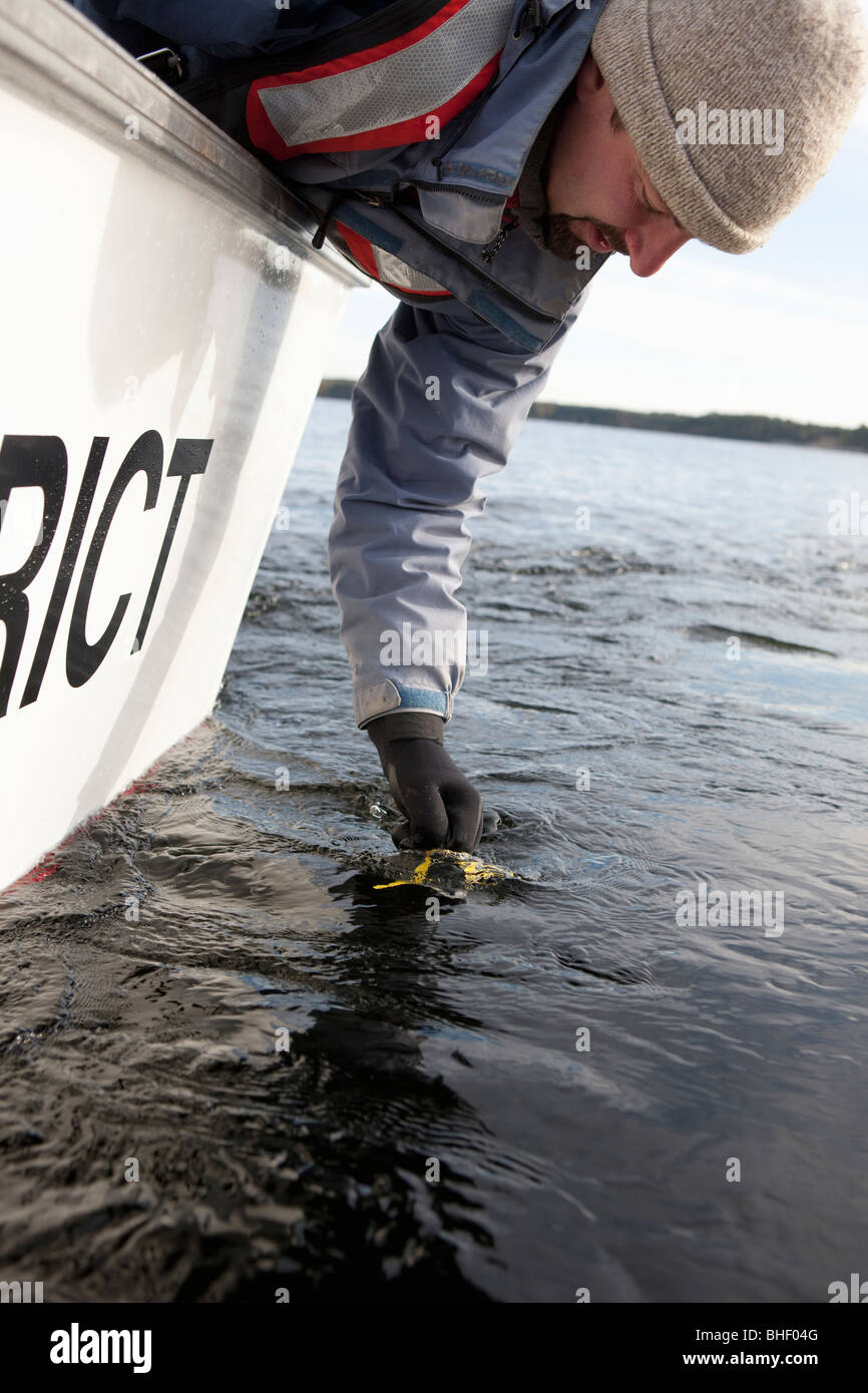 Scientist filling water sample in whirl pak Stock Photo - Alamy