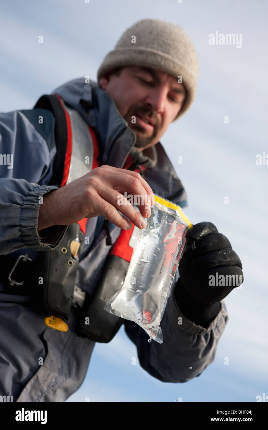 Scientist holding water sample in whirl pak Stock Photo - Alamy