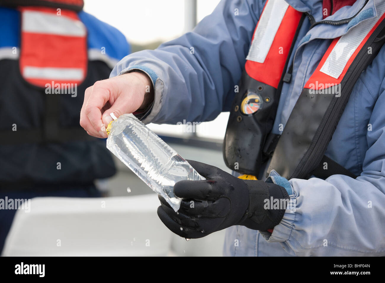 Scientist filling water sample in whirl pak Stock Photo - Alamy