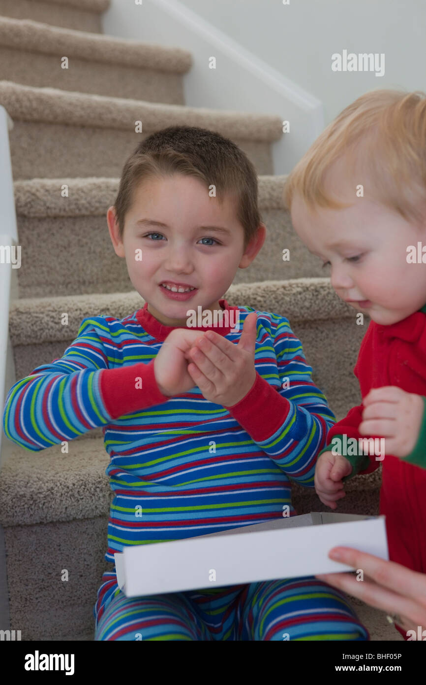 Boy signing the word 'Write' in American Sign Language sitting with his ...