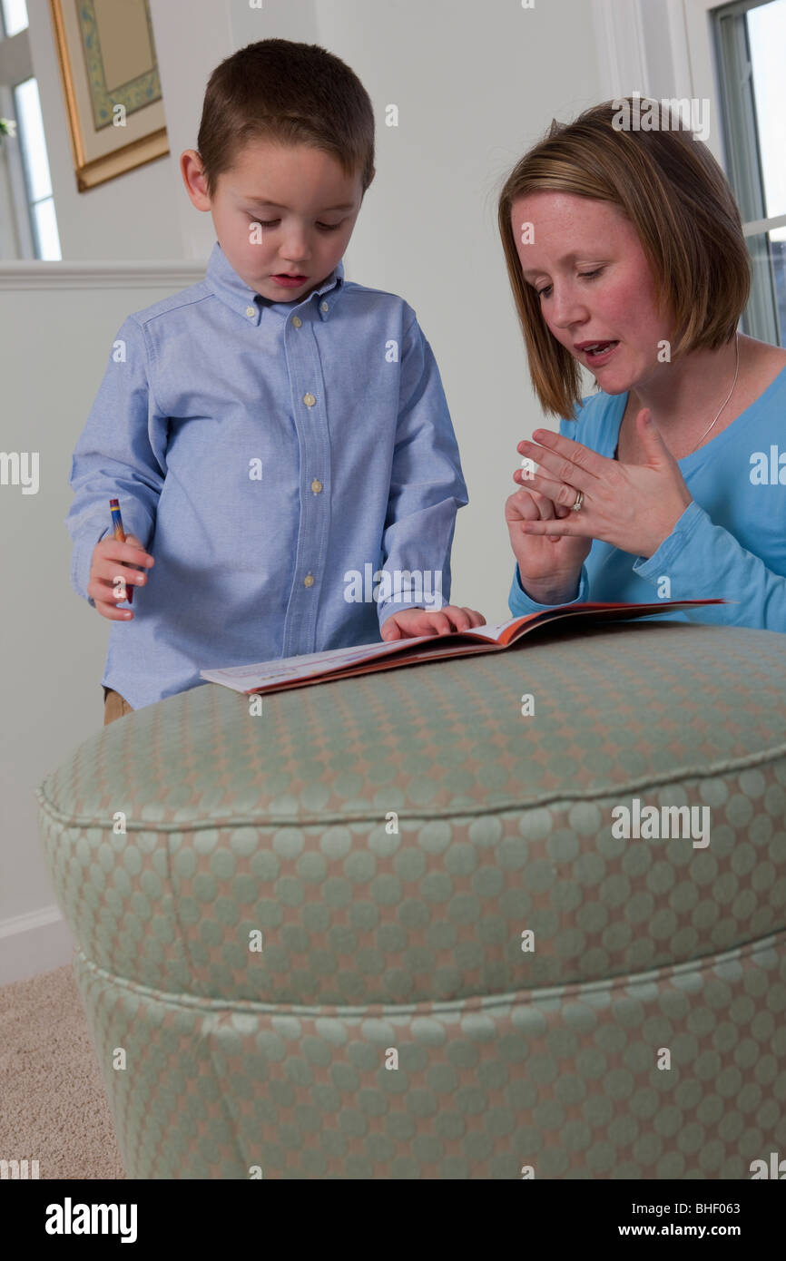 Woman signing the word 'Write' in American Sign Language while teaching ...