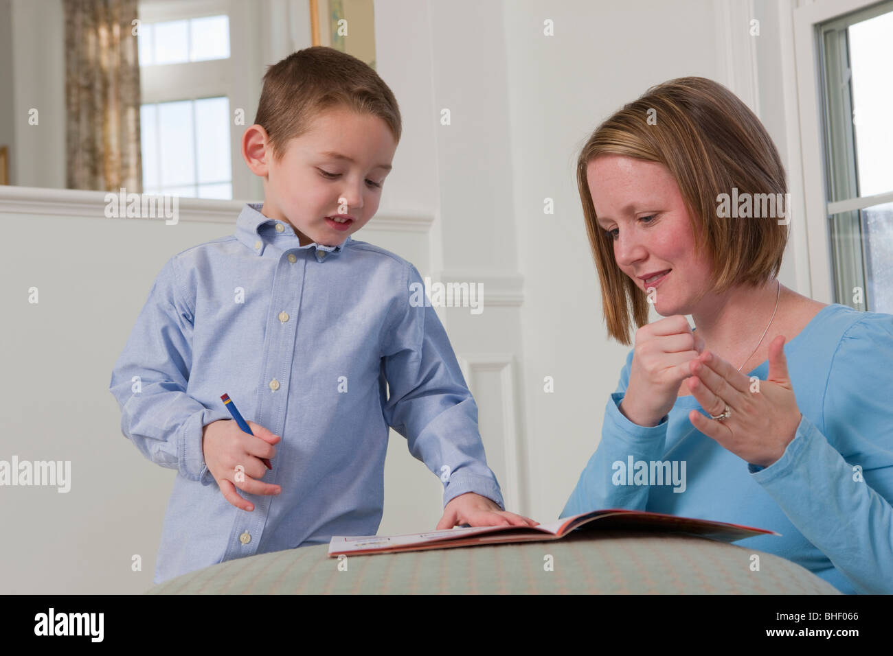 Woman signing the word 'Draw' in American Sign Language while teaching ...