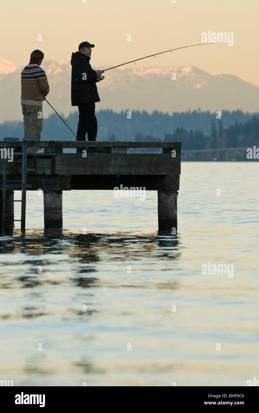 Two men fish off a pier in Seattle's Lake Washington Stock Photo - Alamy