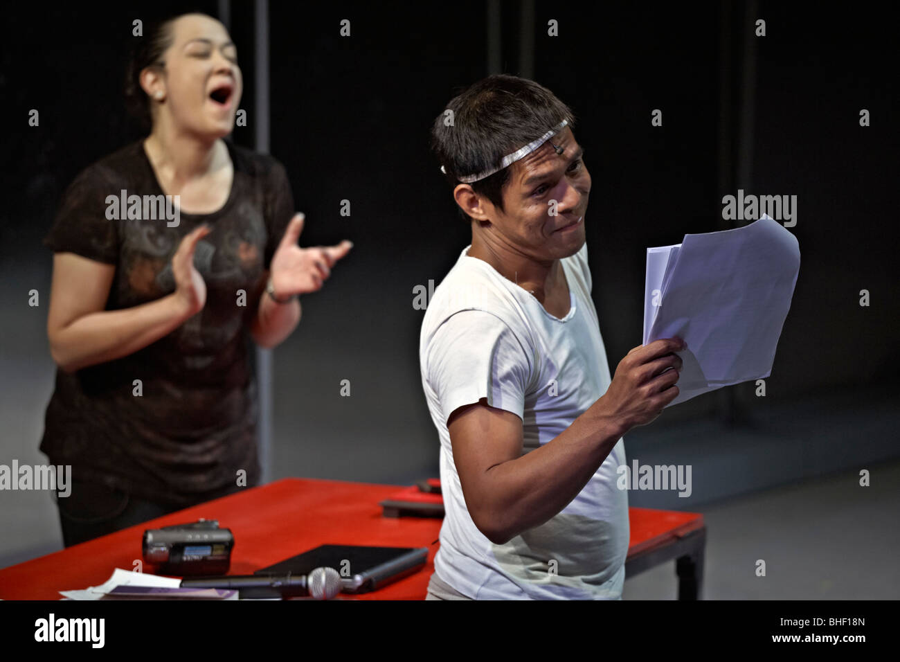 Actors rehearsing on stage and reading script. Thailand S. E. Asia ...