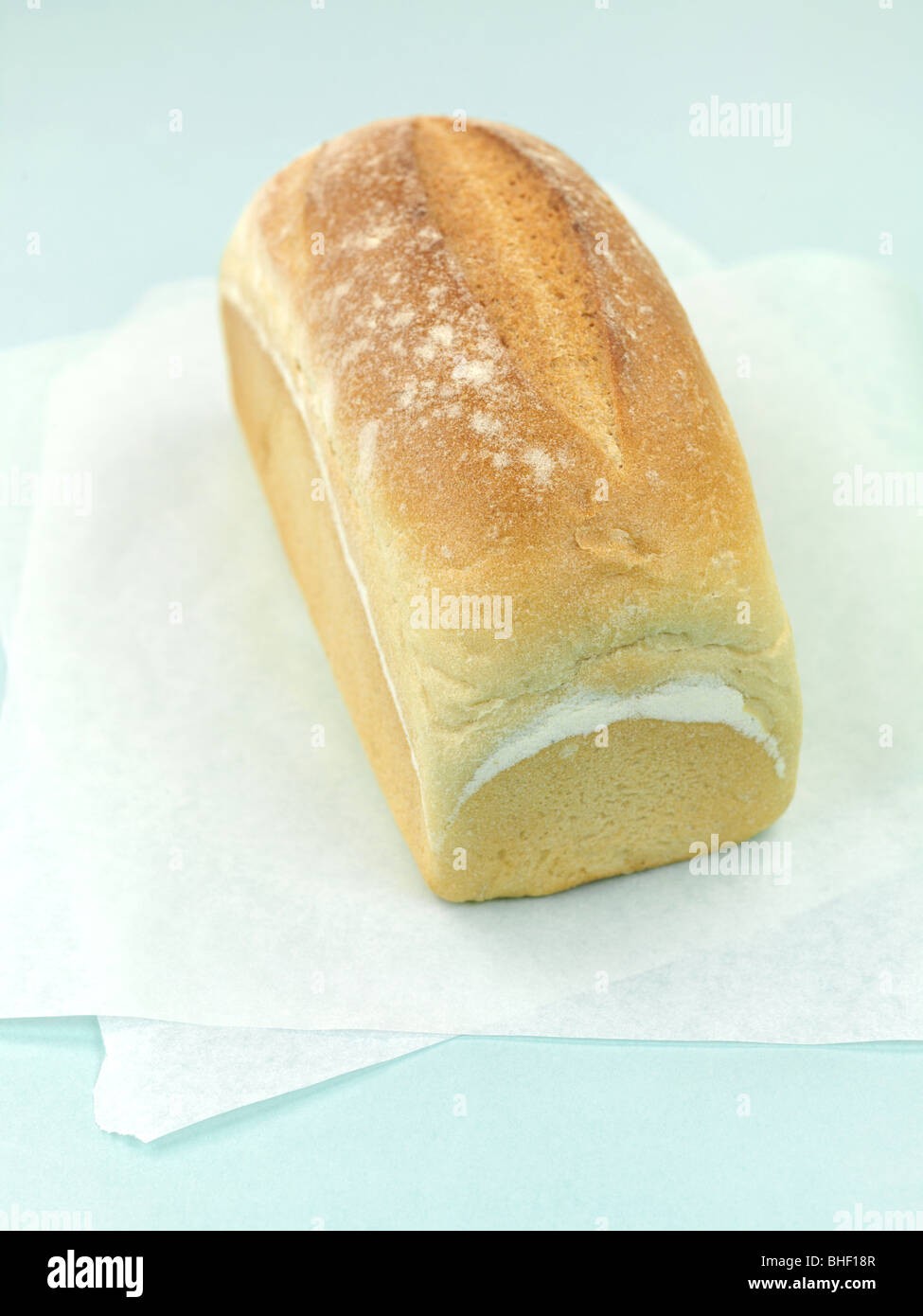 A loaf of bread isolated against a blue background Stock Photo - Alamy