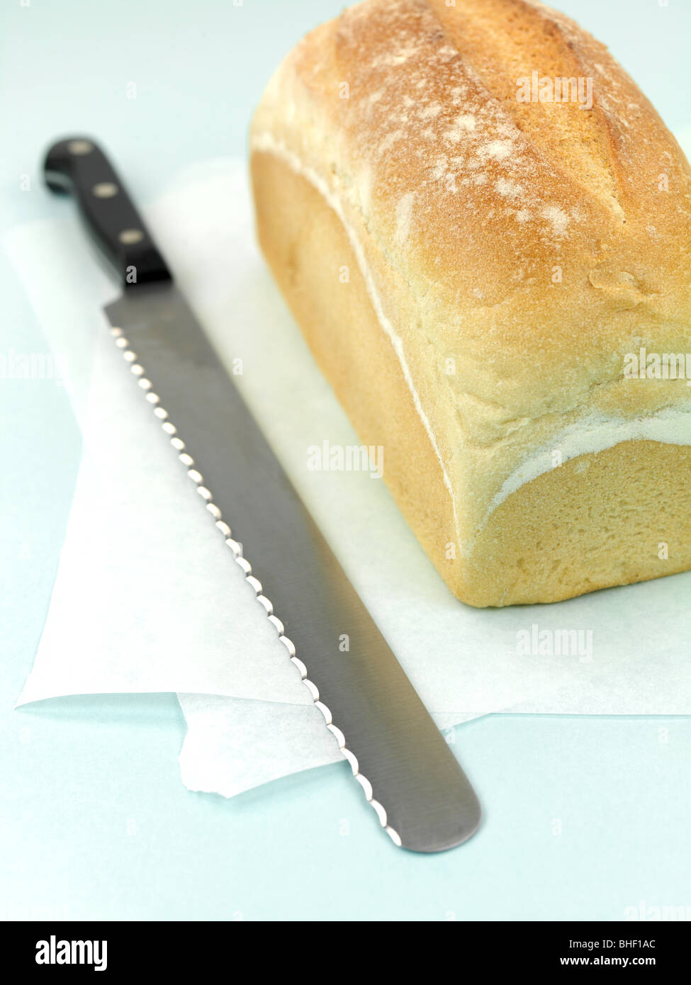 A loaf of bread isolated against a blue background Stock Photo - Alamy