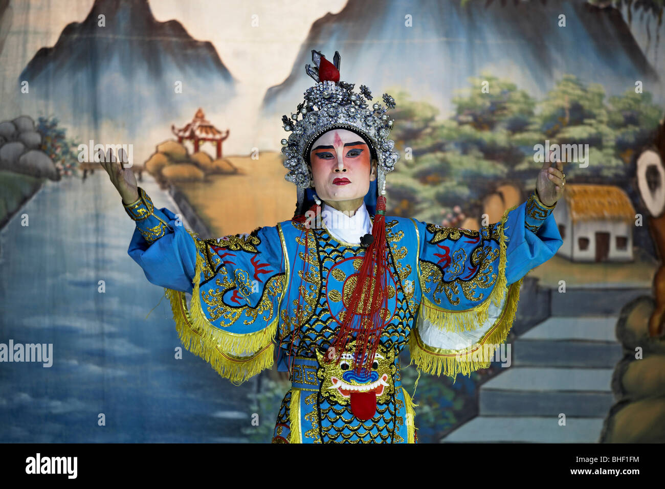 Chinese opera actor on stage in traditional colourful costume and make ...