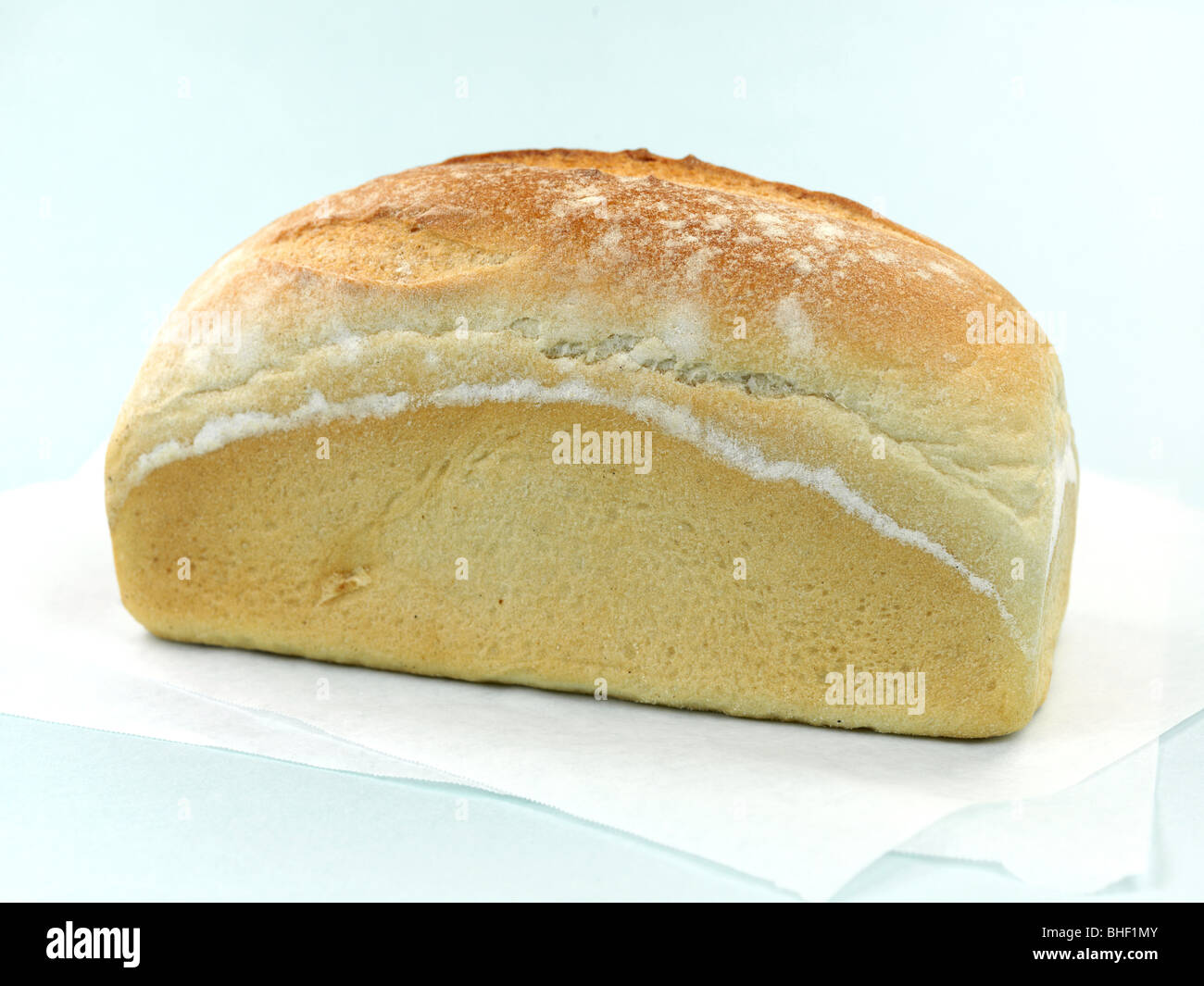 A loaf of bread isolated against a blue background Stock Photo - Alamy
