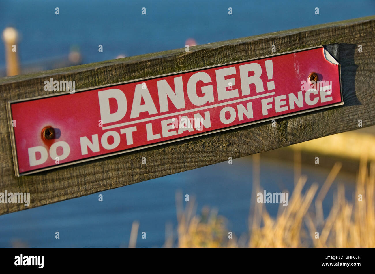 Close up of danger do not lean on fence warning sign Whitby North Stock ...