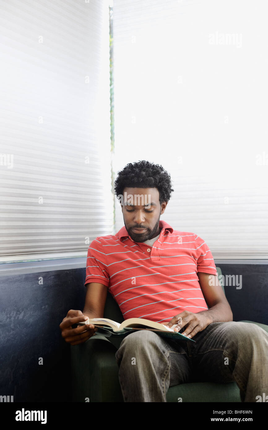 Black man reading book Stock Photo - Alamy