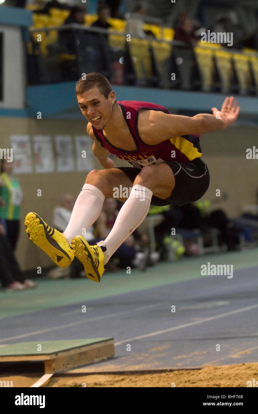 Male athlete competes in the triple jump at a Grand Prix meet in ...