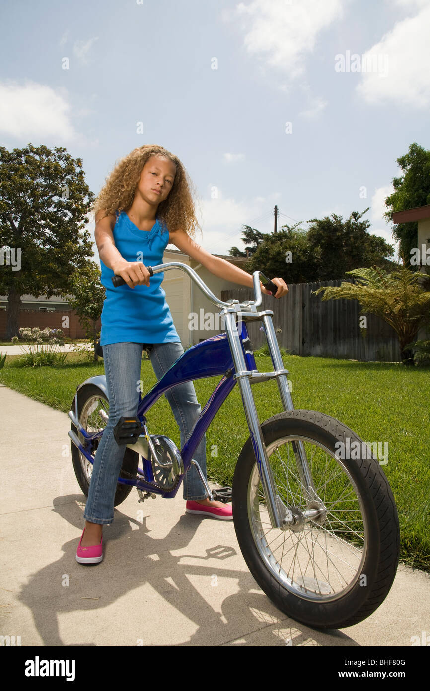 Mixed race girl on bicycle Stock Photo - Alamy