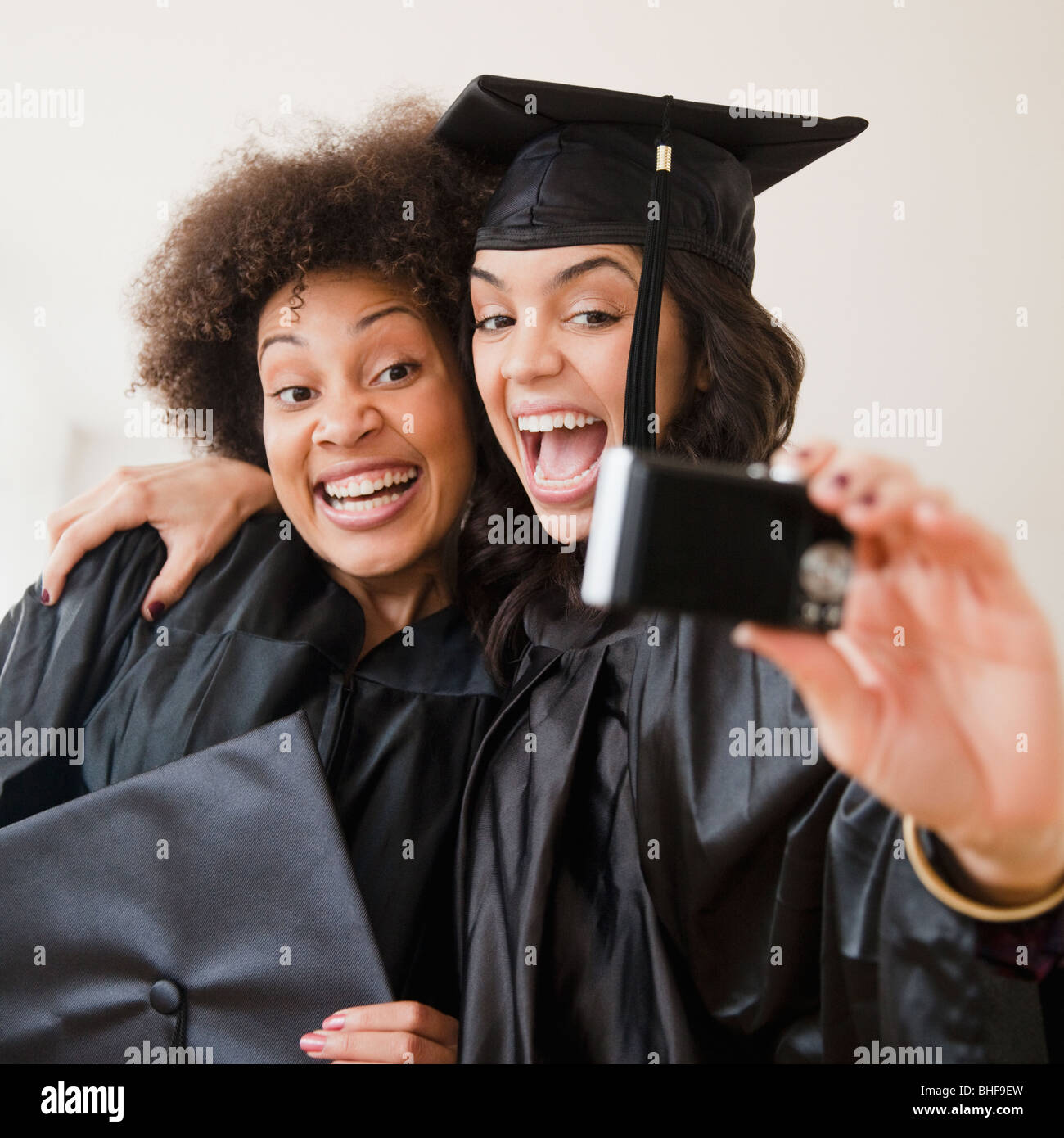Graduating friends taking self-portrait Stock Photo - Alamy