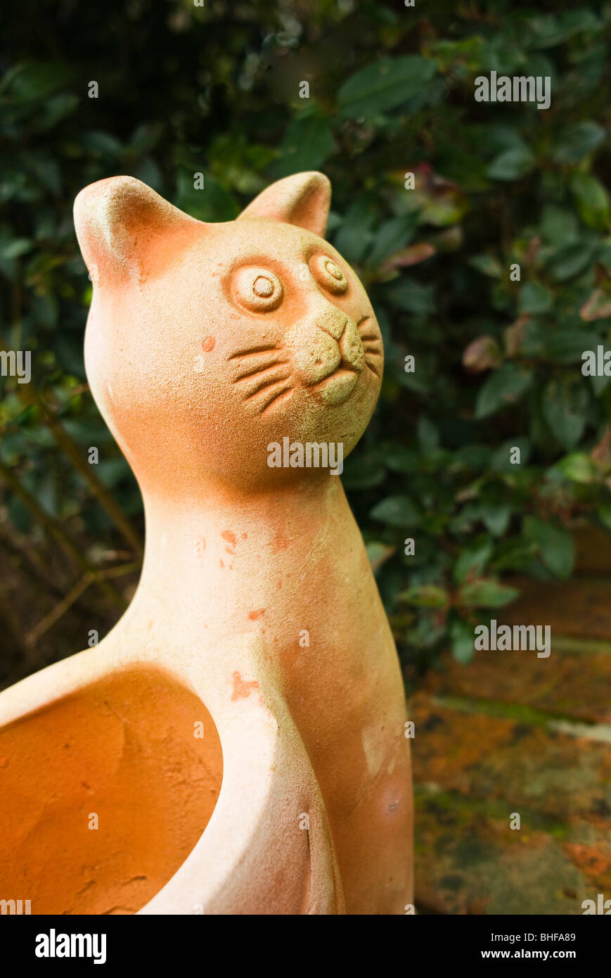 Smug expression on terracotta catcat, feline, effigy Stock Photo - Alamy