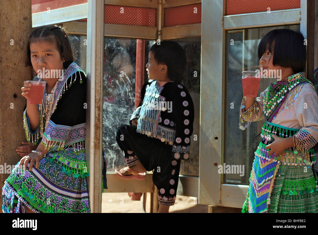 Hmong children dressed in traditional costumes drinking lemonade, Mae ...